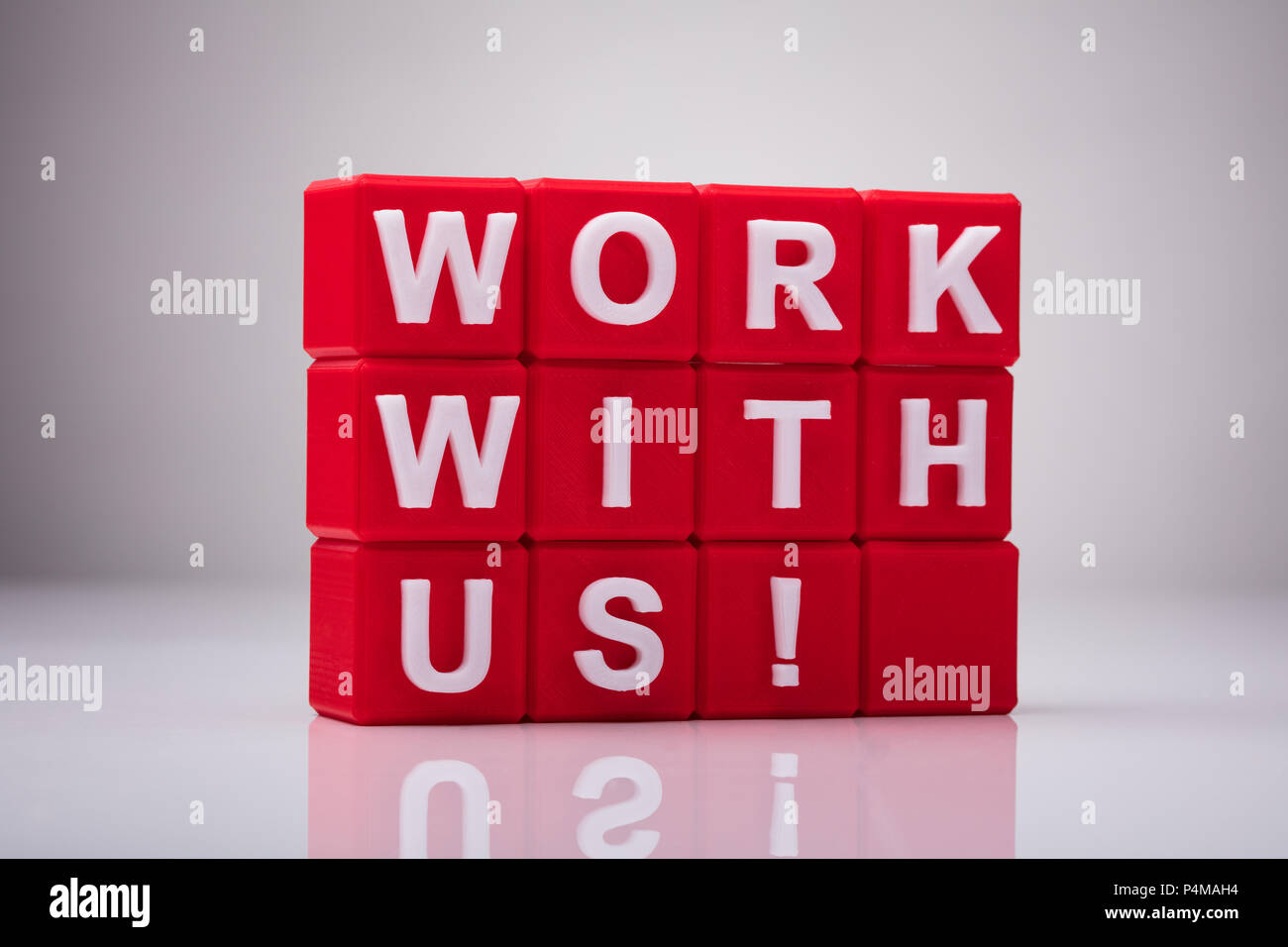 High Angle View Of Red Cubes Showing Work With Us Text Over White ...