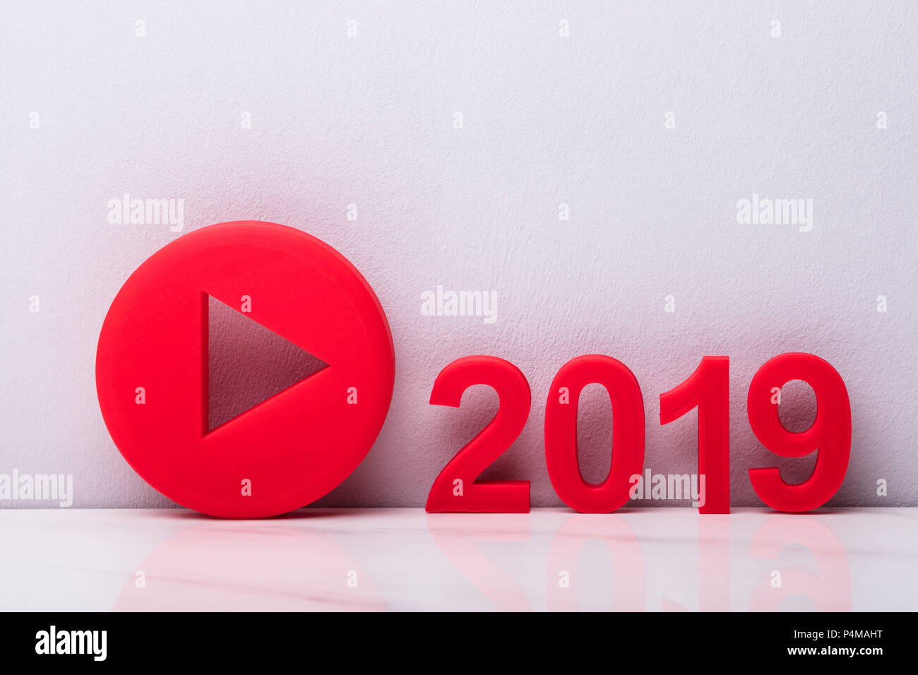 Red Play Icon Near Year 2019 Against White Background Stock Photo - Alamy