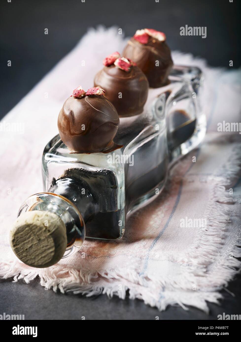Handmade pralines in dark chocolate with a strawberry and balsamic ...