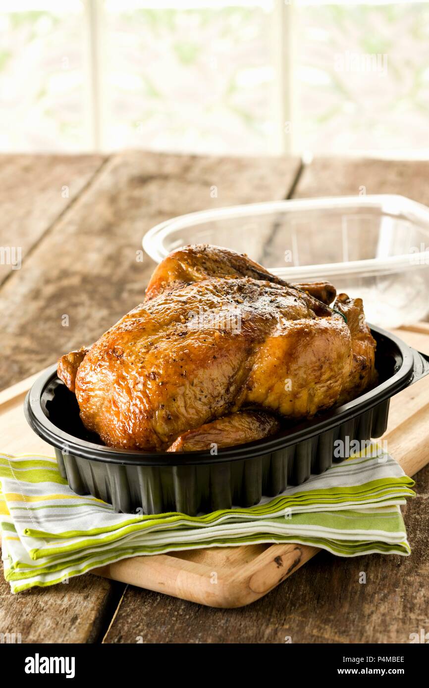 Rotisserie Chicken in Plastic Container with Lid Off Stock Photo - Alamy