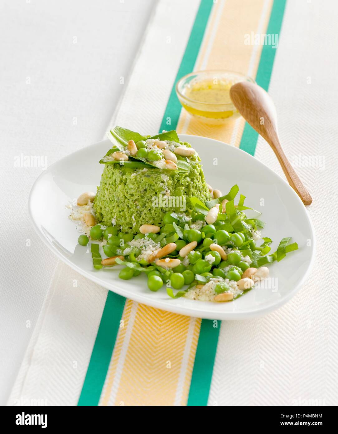 Pea flan with a pea and rocket salad and pine nuts Stock Photo - Alamy