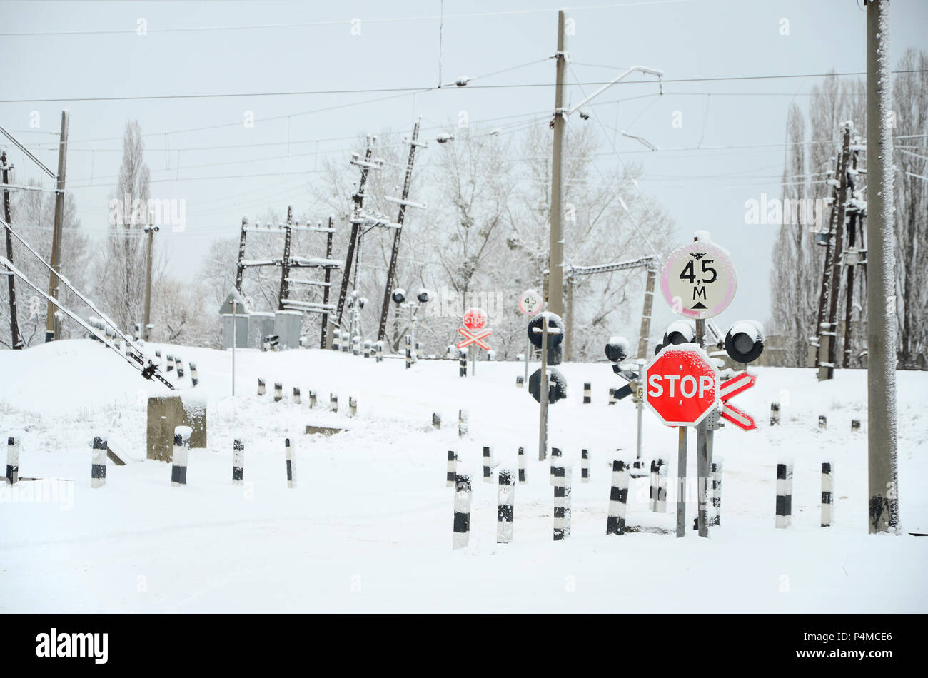Railway crossing without a barrier with a lot of warning signs in the ...