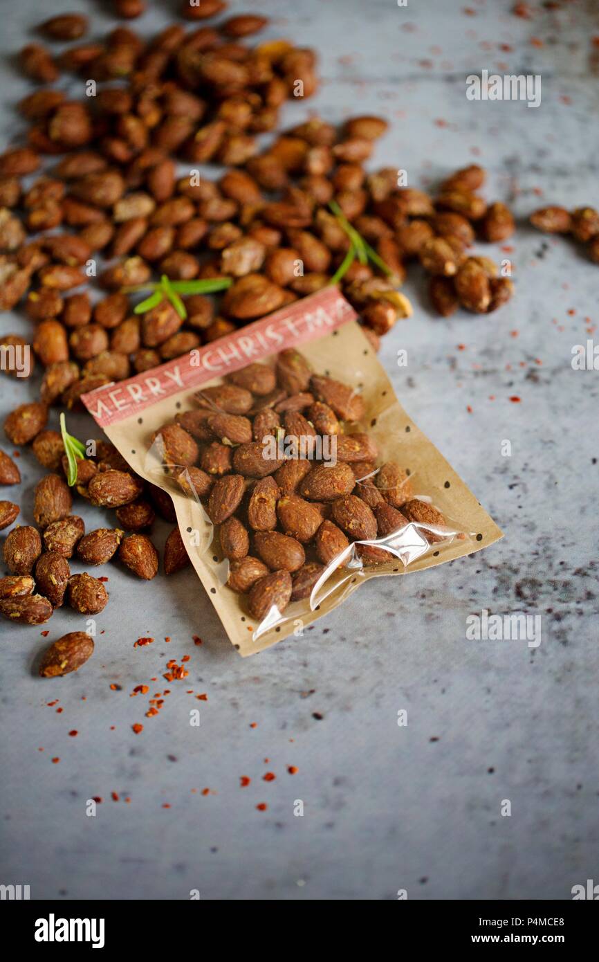 Roasted rosemary and chilli almonds, with some packaged Stock Photo - Alamy