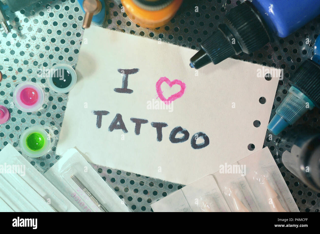 I love tattoo. The text is written on a small sheet of paper among ...
