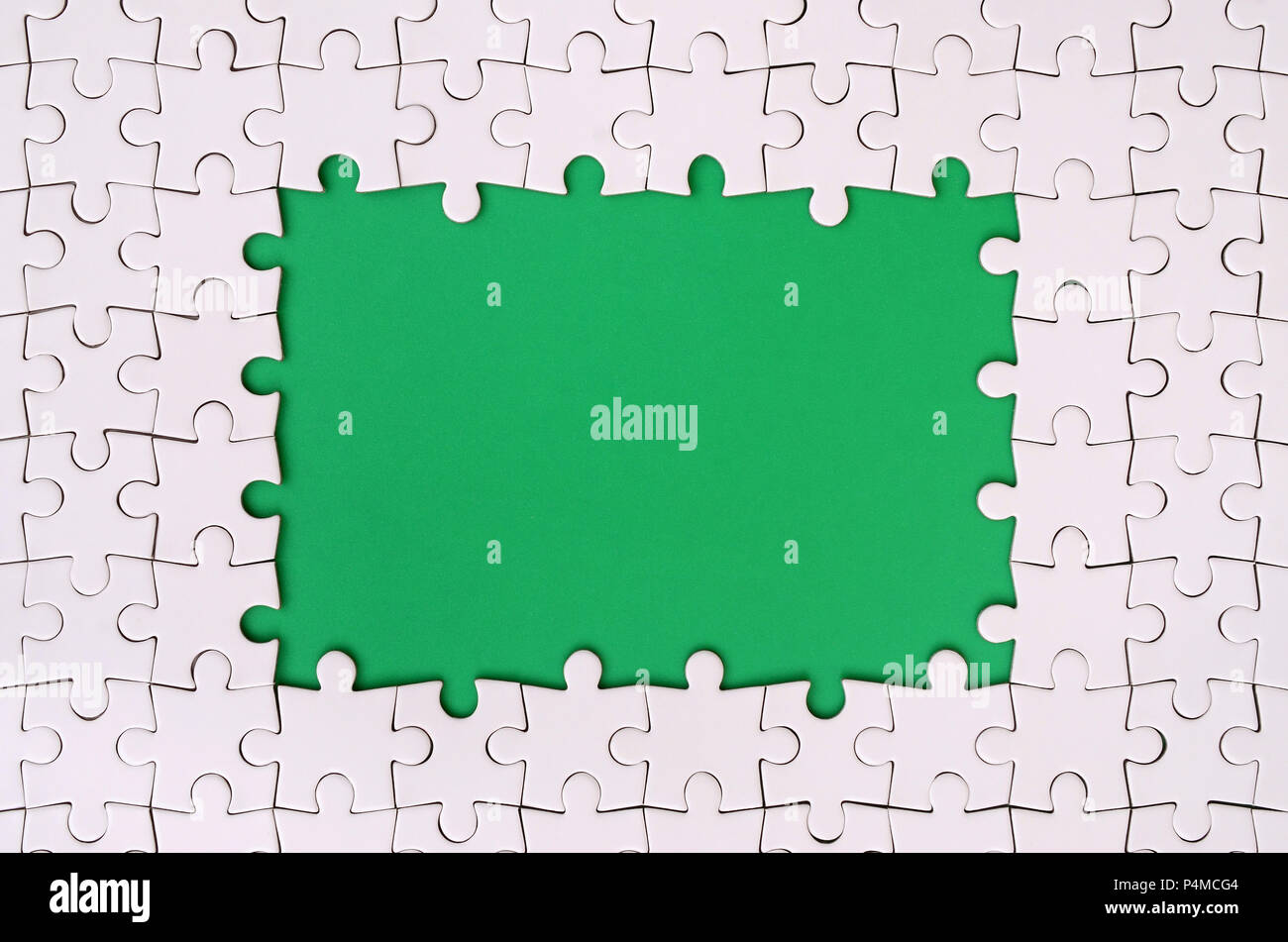 Framing in the form of a rectangle, made of a white jigsaw puzzle ...