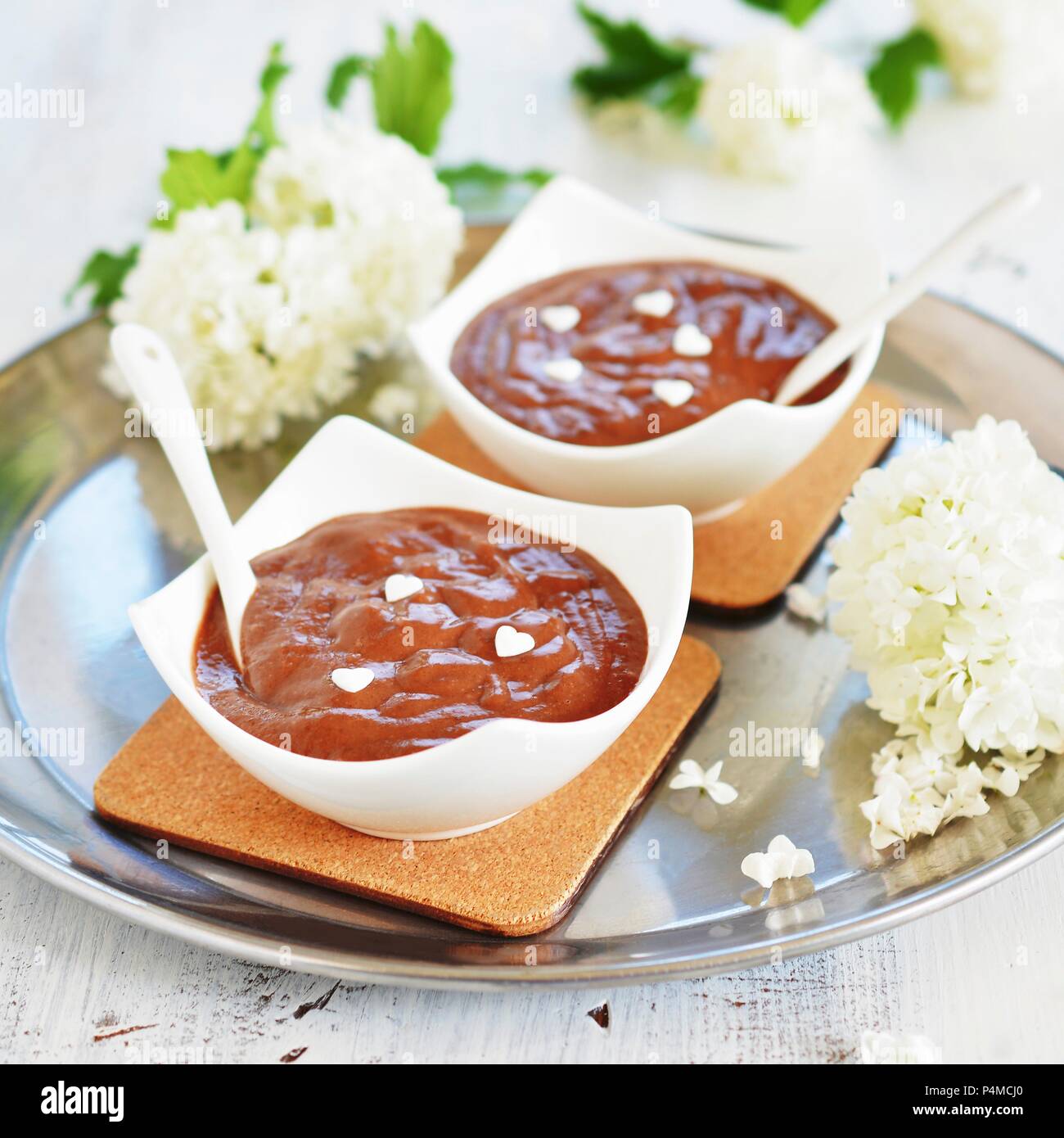 Two bowls of chocolate pudding with white sugar hearts Stock Photo - Alamy