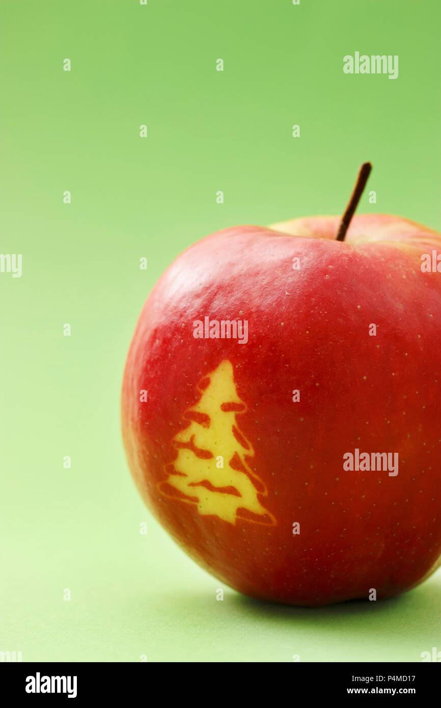 Red apple with a Christmas tree Stock Photo - Alamy