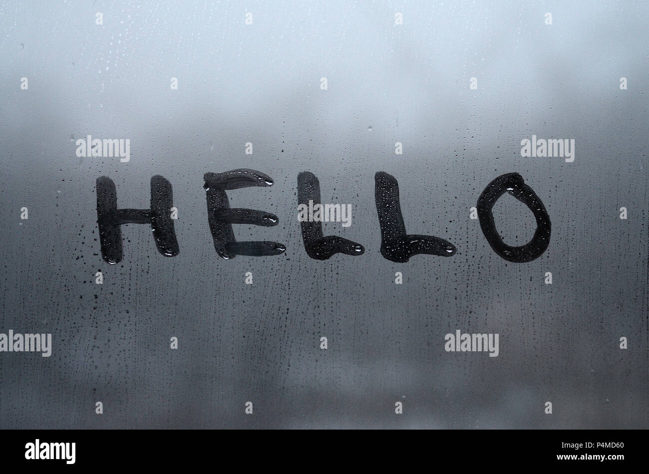The English word Hello is written with a finger on the surface of the ...
