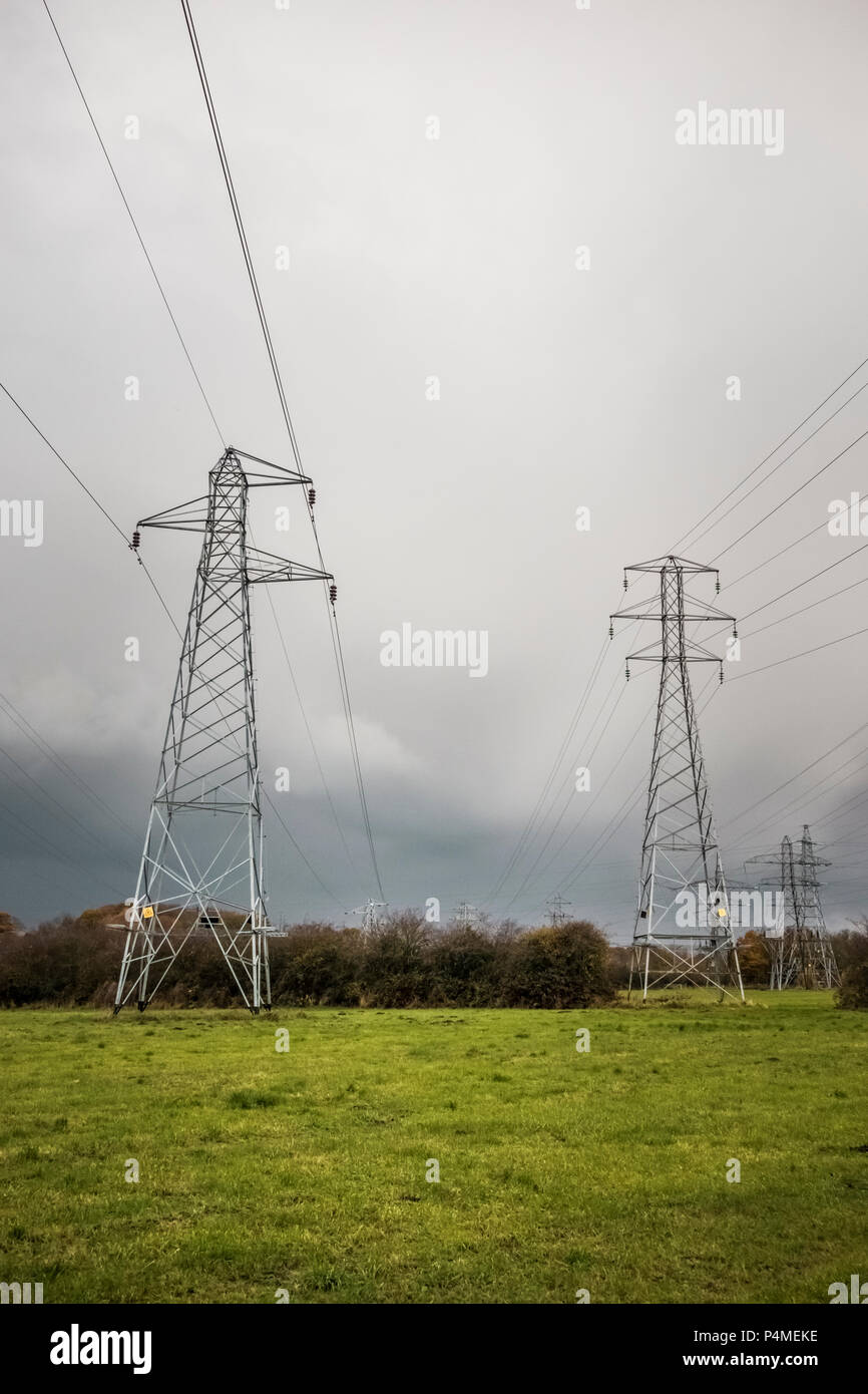 Sinister looking power pylons with a cloudy sky in the background Stock ...