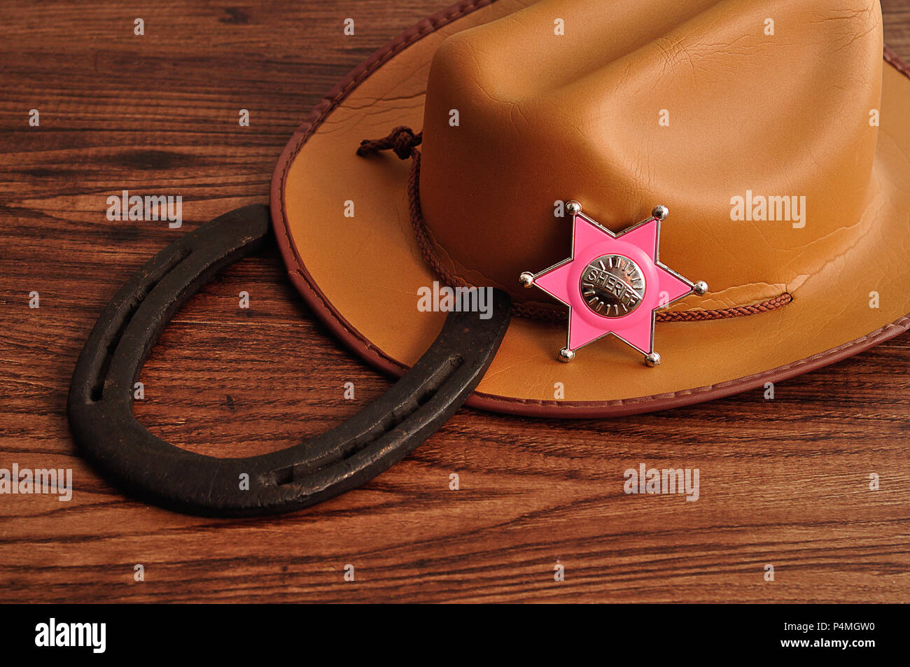 A sheriff badge with a brown cowboy hat and a horse shoe Stock Photo ...