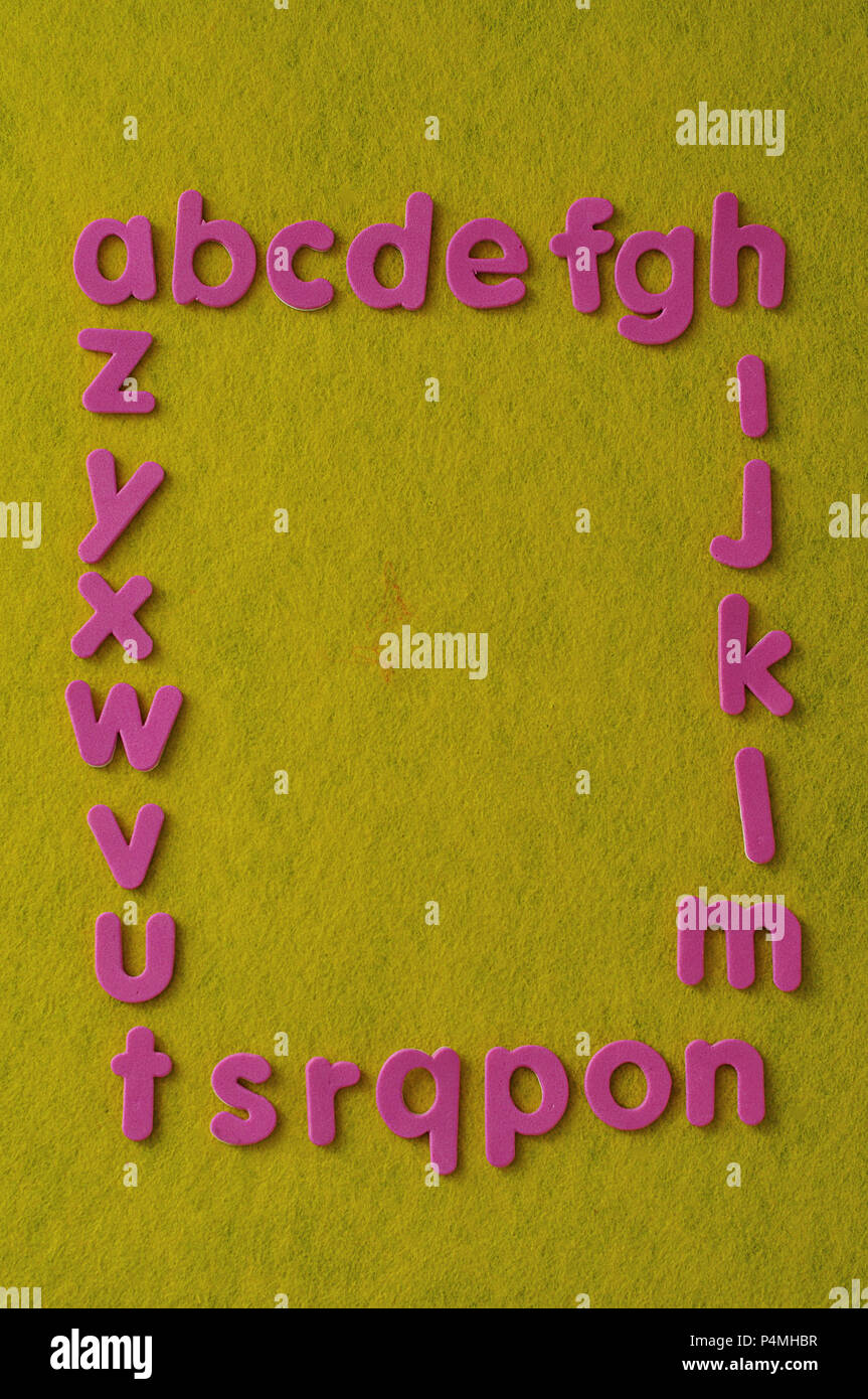 The alphabet in pink letters on a yellow background Stock Photo - Alamy