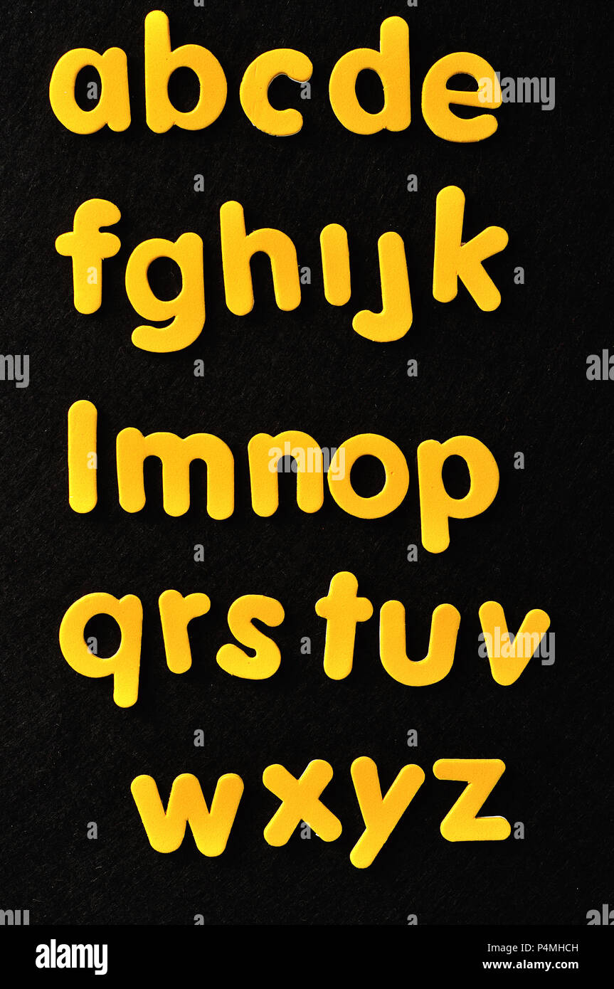 The alphabet in yellow letters on a black background Stock Photo - Alamy