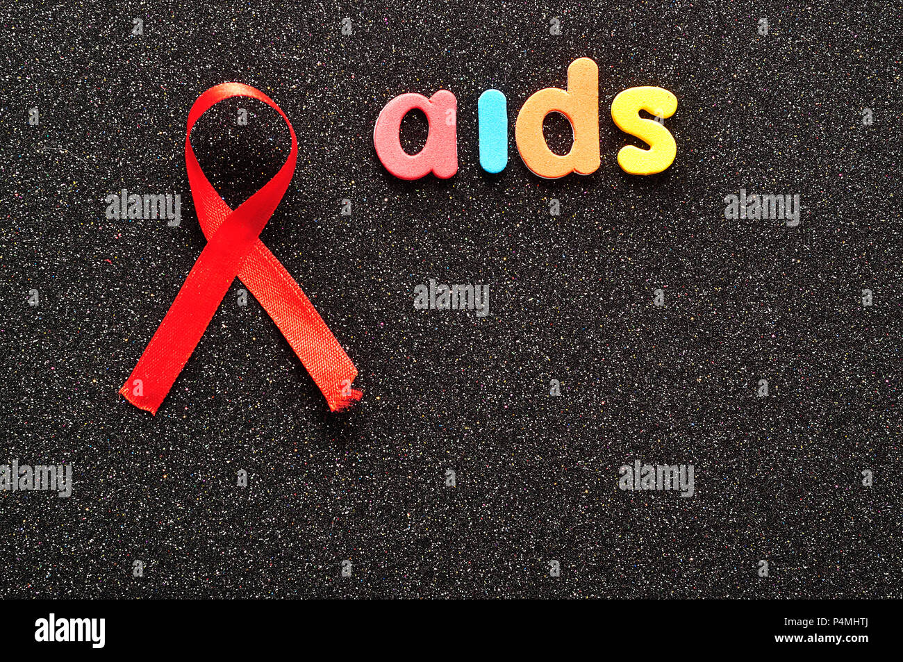 The word aids with a red awareness ribbon Stock Photo - Alamy