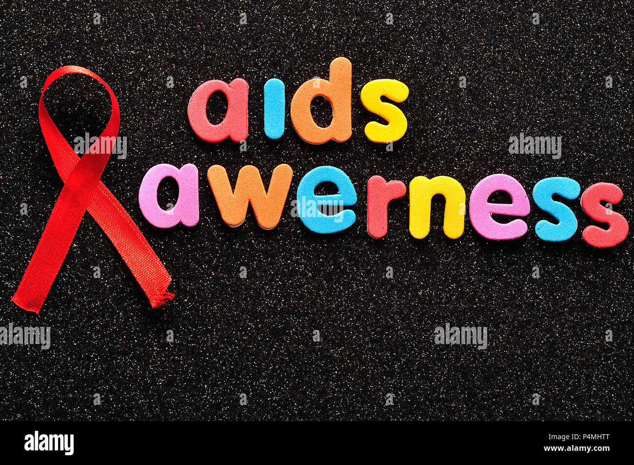 The words aids awareness with a red awareness ribbon Stock Photo - Alamy