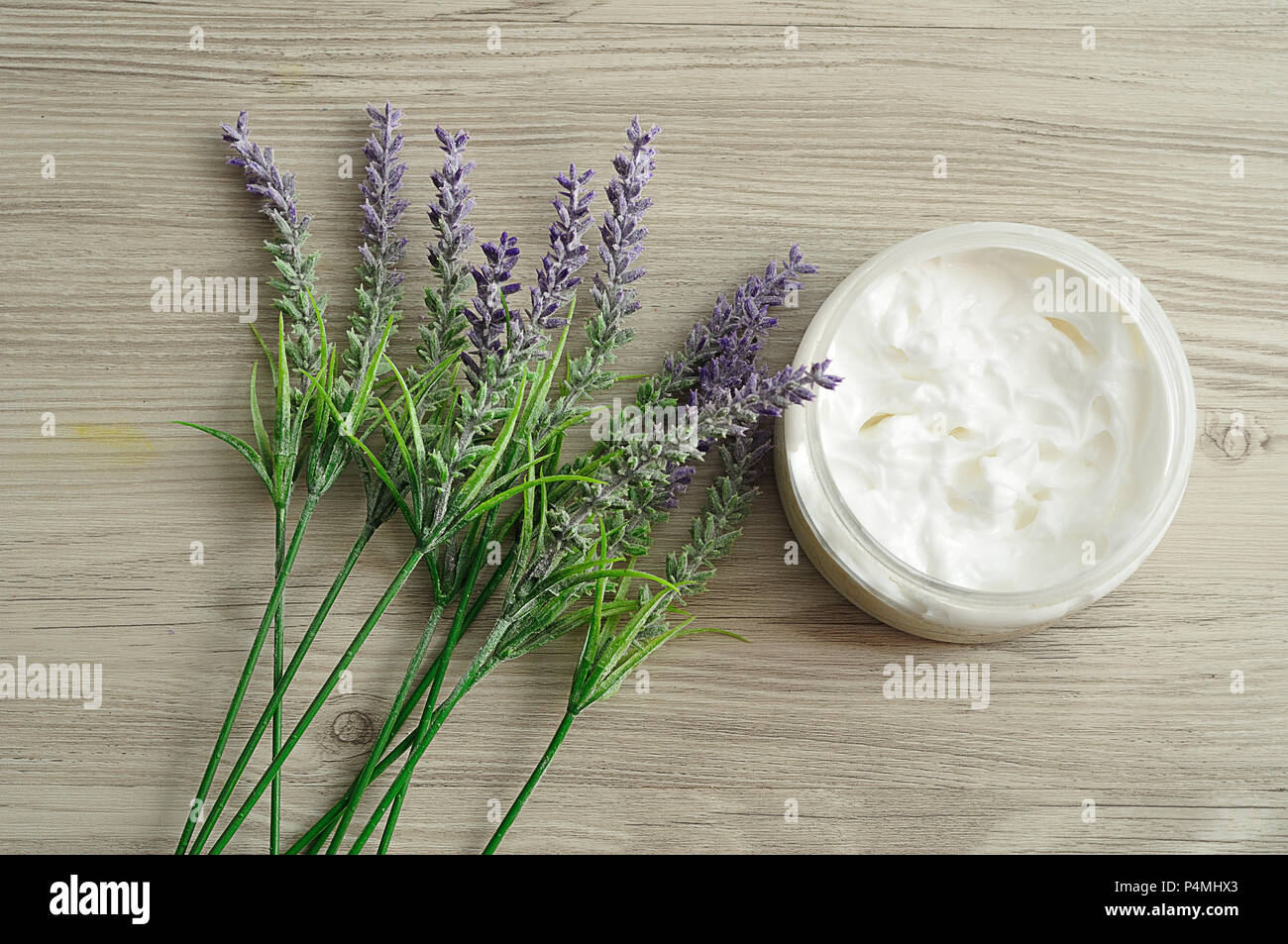 A bunch of lavender displayed with a container white body lotion Stock ...