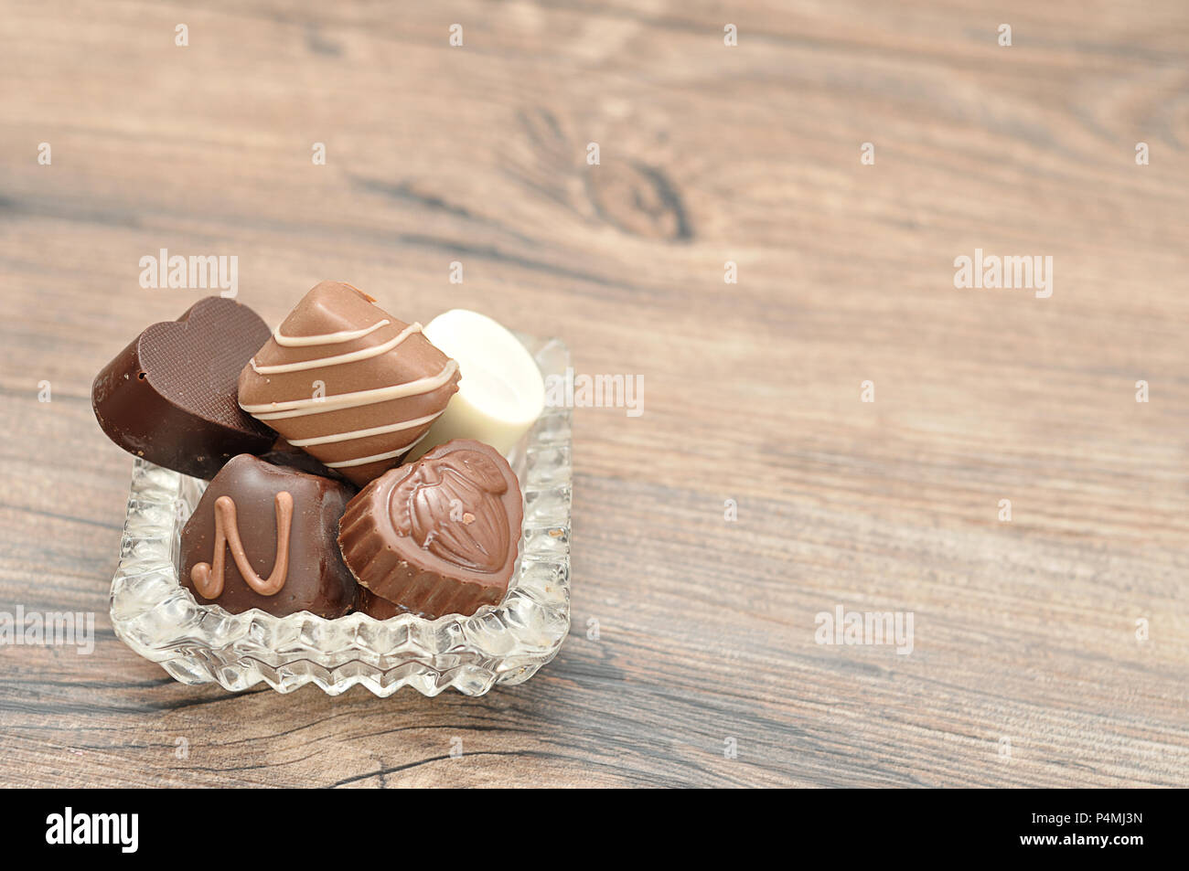 A variety of chocolates displayed in a fancy glass container Stock ...