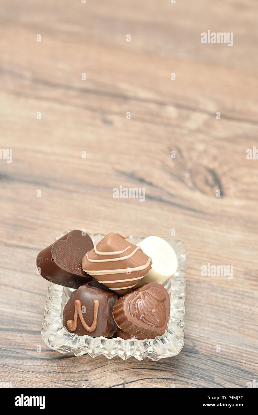 A variety of chocolates displayed in a fancy glass container Stock ...