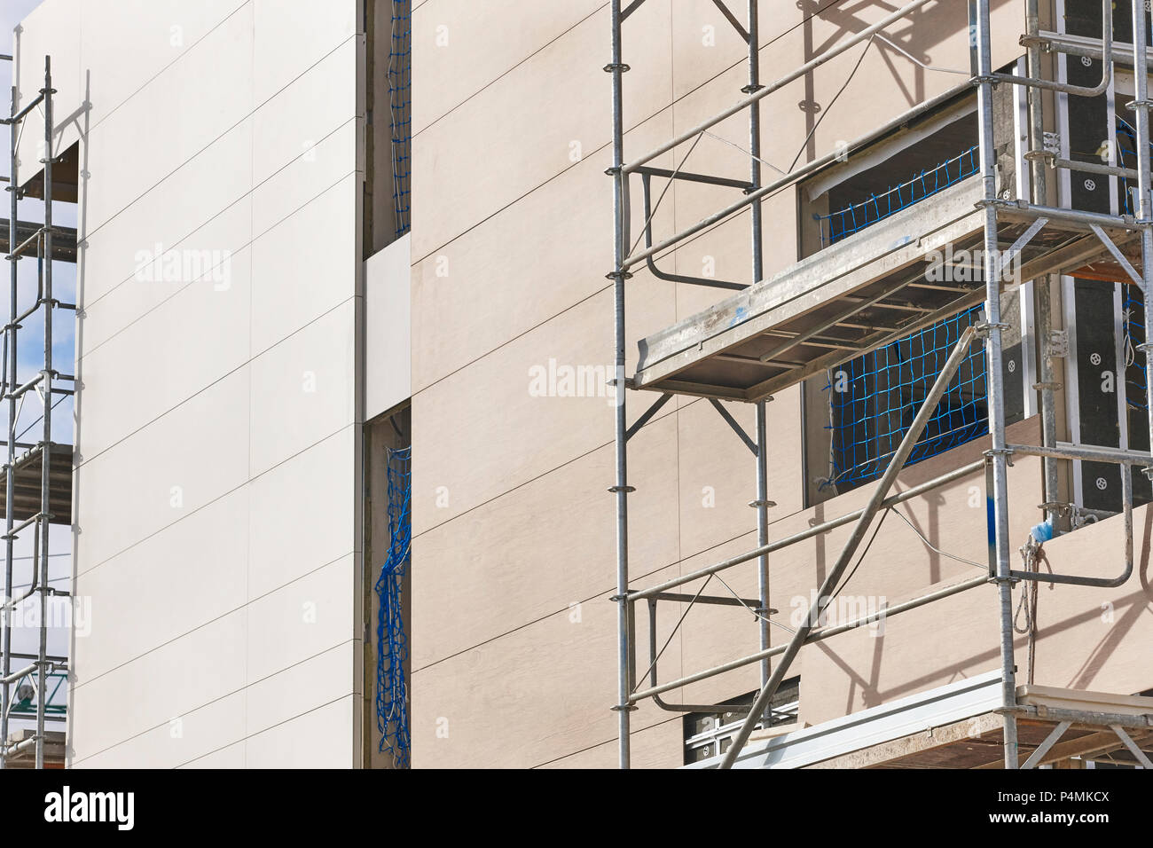 Building facade under construction. Insulation material and tiles ...