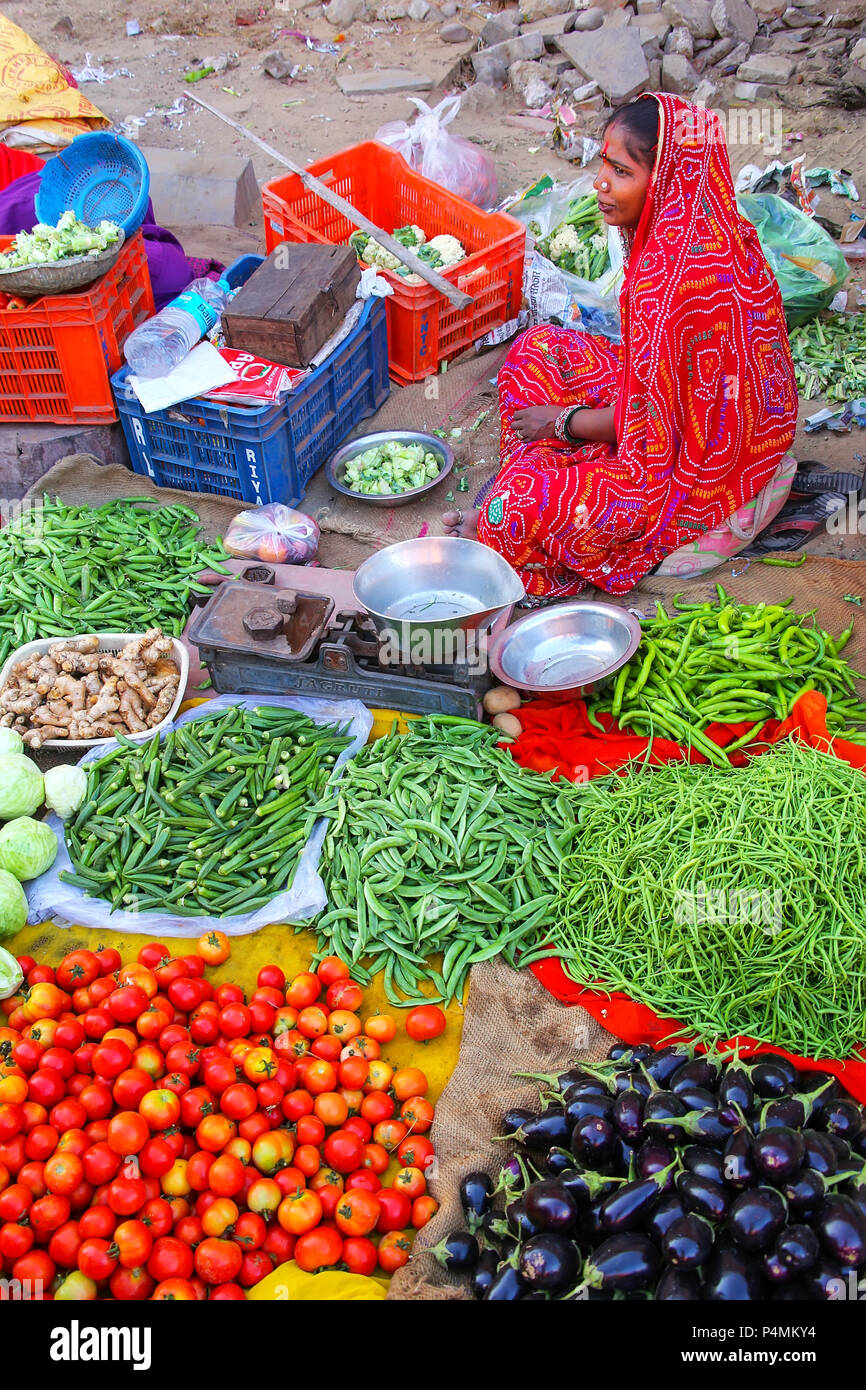 Local woman selling vegetables at the street market in Jaipur, India ...