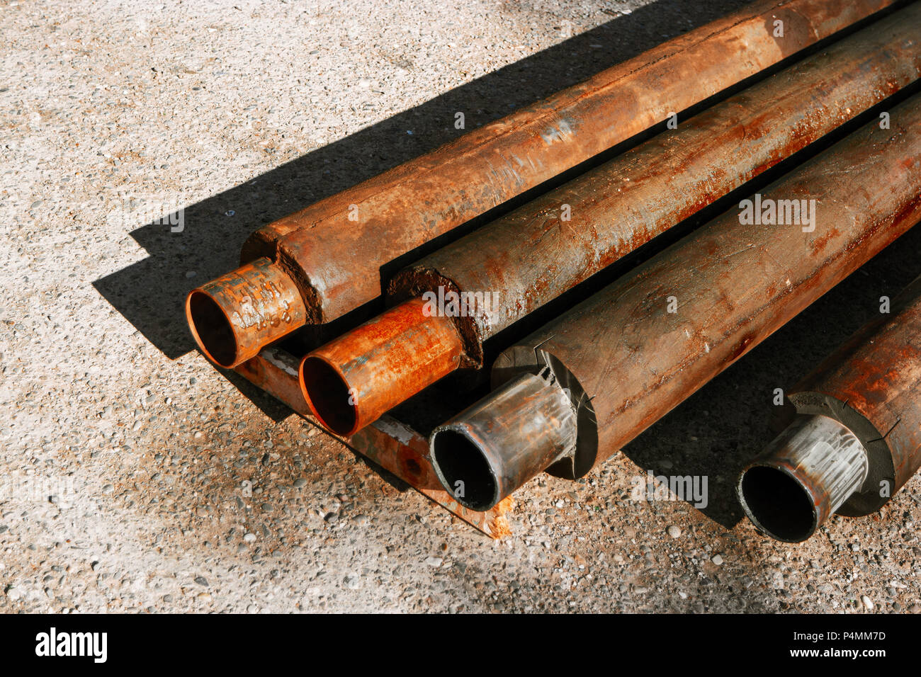 Old rusty hot water pipes on a ground , can be used as industrial ...
