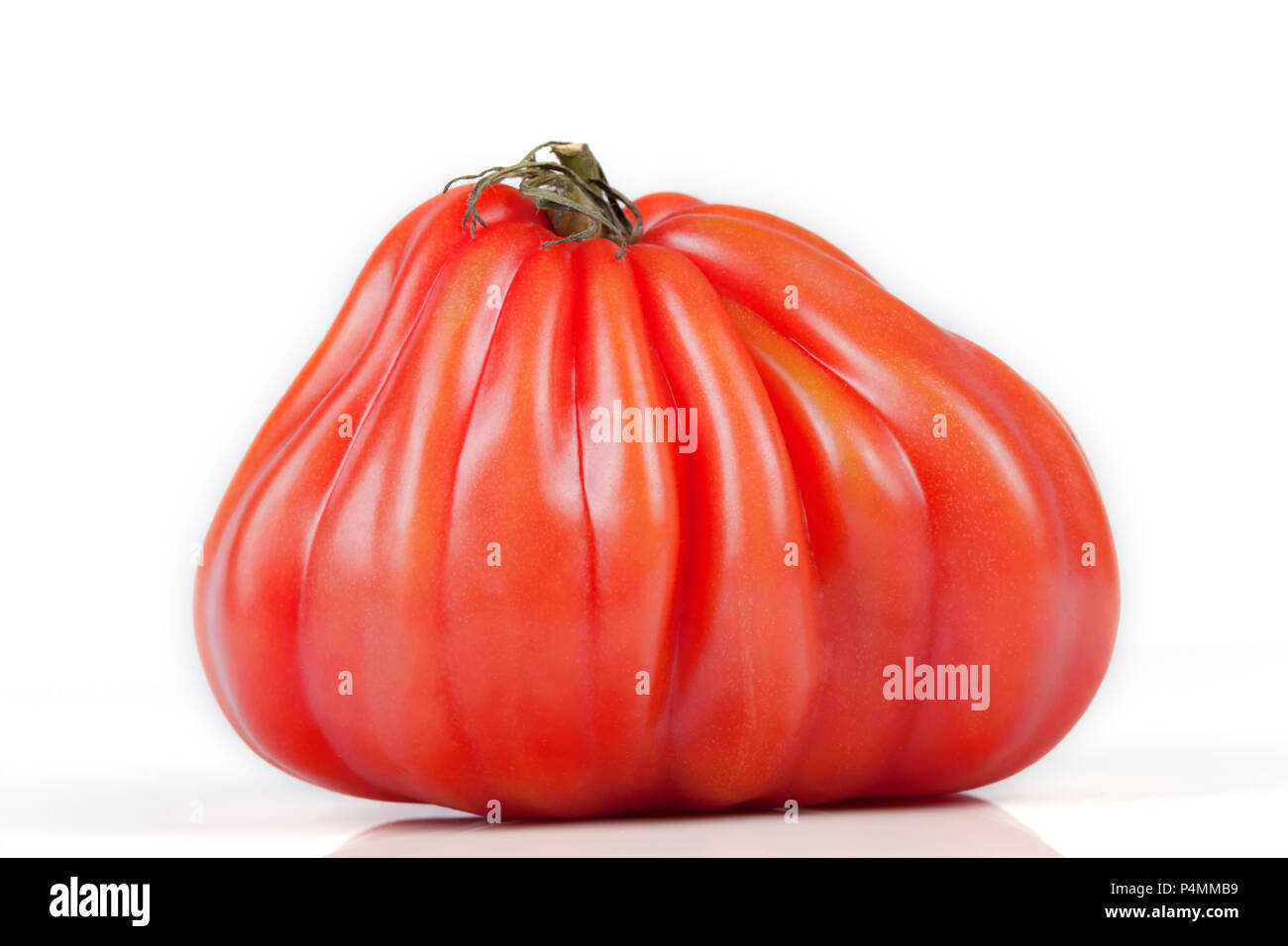 A weird tomato isolated on white background Stock Photo - Alamy