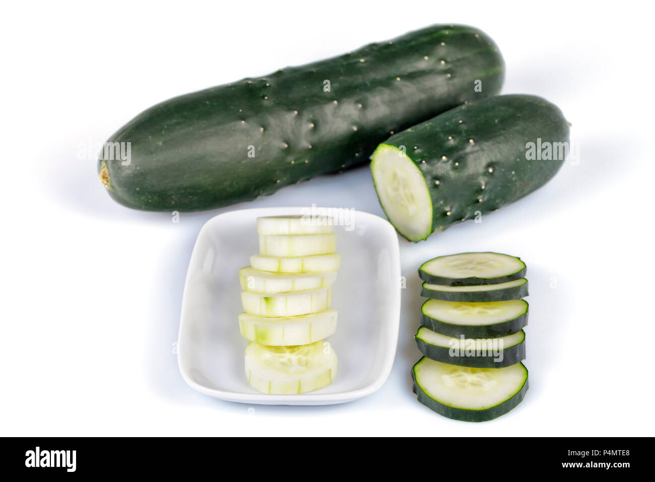 Cucumber cut into slices isolated on white background Stock Photo - Alamy