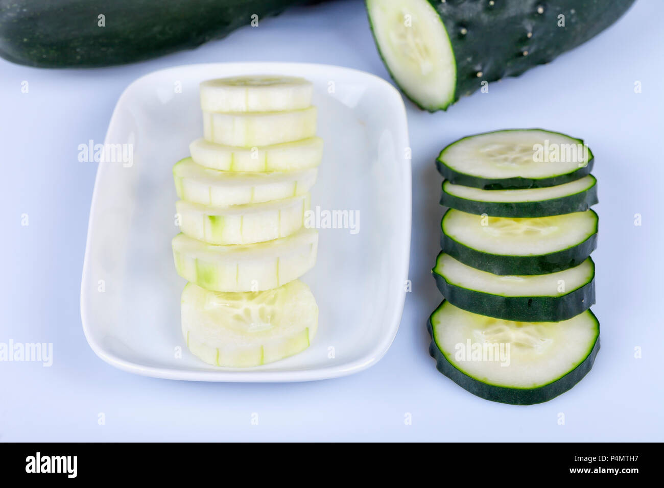 Cucumber cut into slices isolated on white background Stock Photo - Alamy