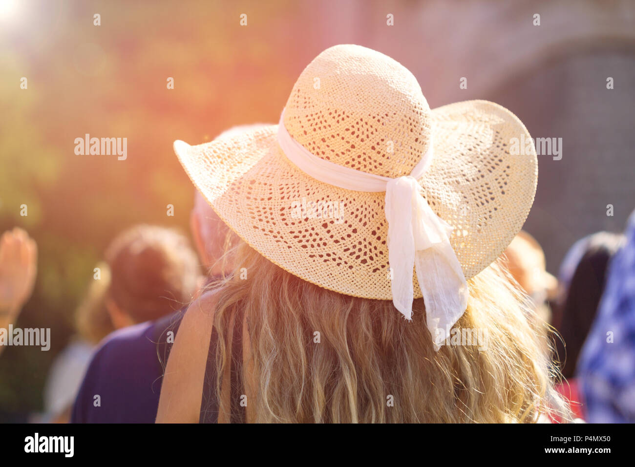 Back view of woman wearing straw hat looking at view hi-res stock ...