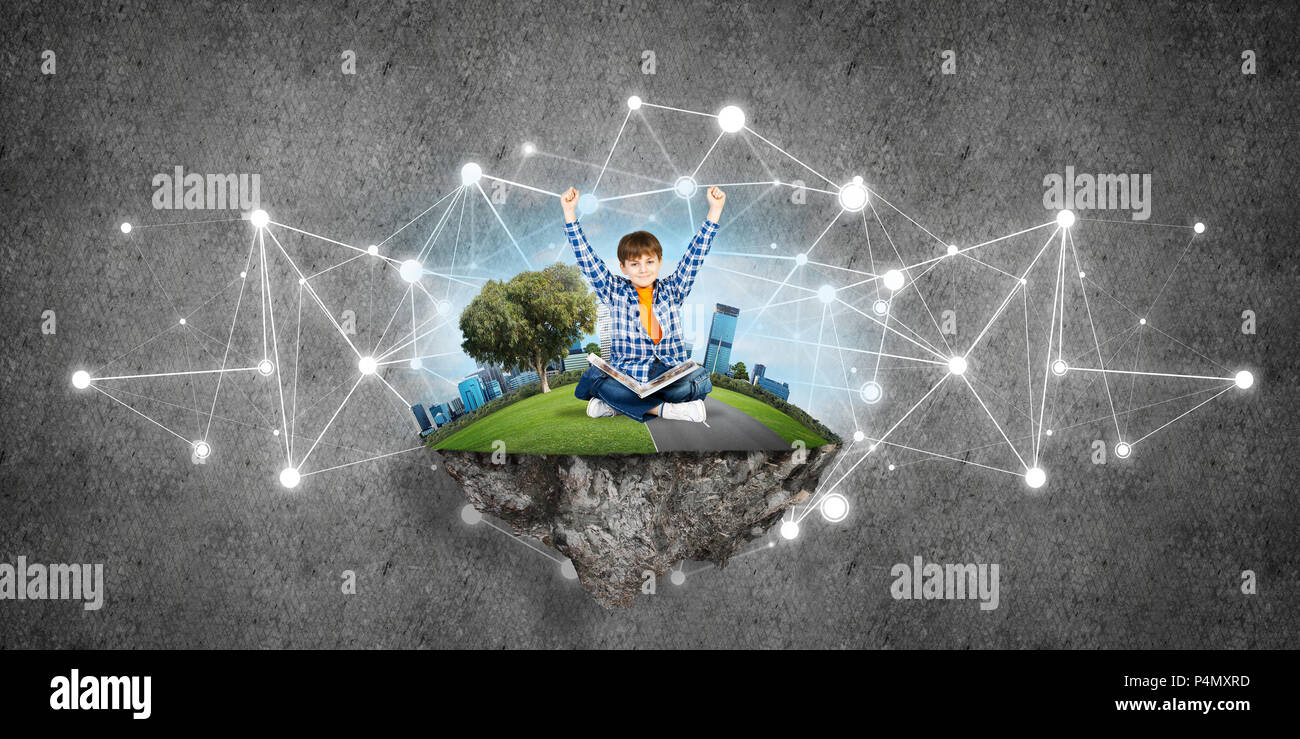 Cute boy of school age with book exploring this great world Stock Photo ...