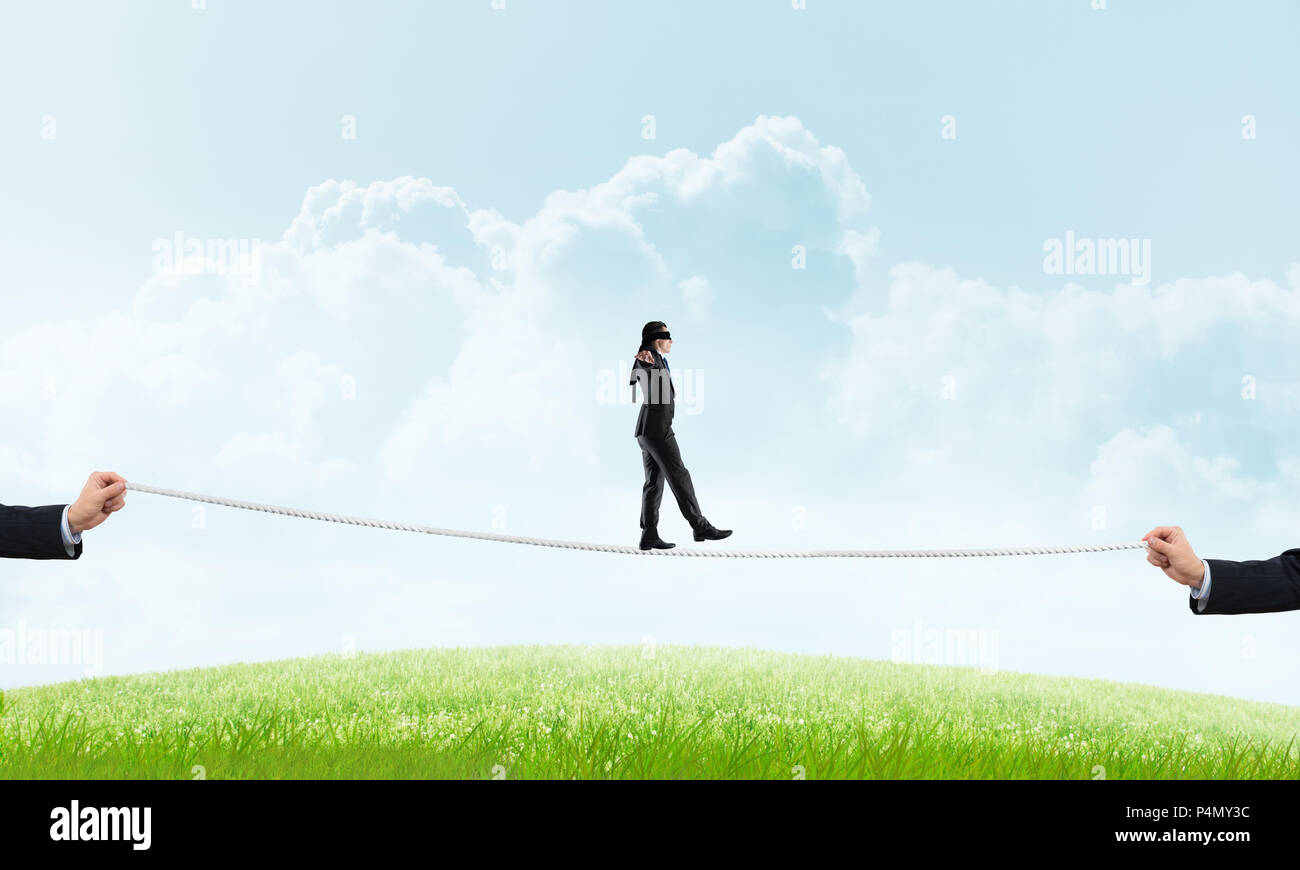 Business concept of risk support and assistance with man balancing on ...