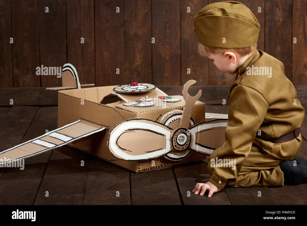 children boy are dressed as soldier in retro military uniforms repair ...