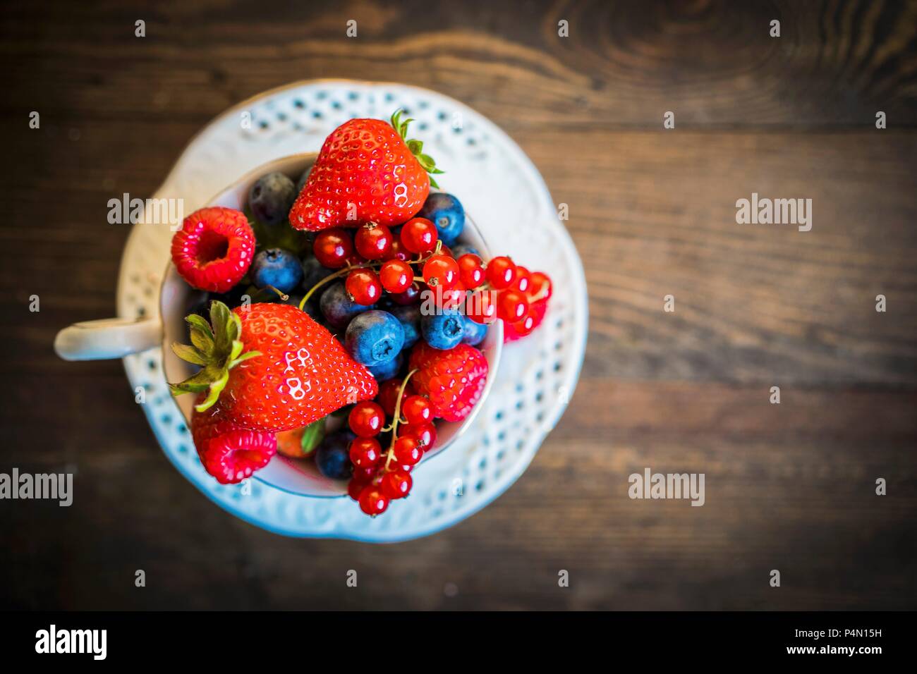 Fresh summer berries in a teacup Stock Photo - Alamy