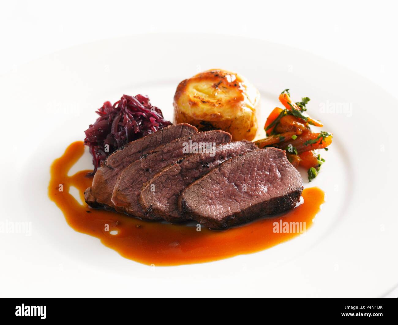 Roast venison with red cabbage Stock Photo - Alamy