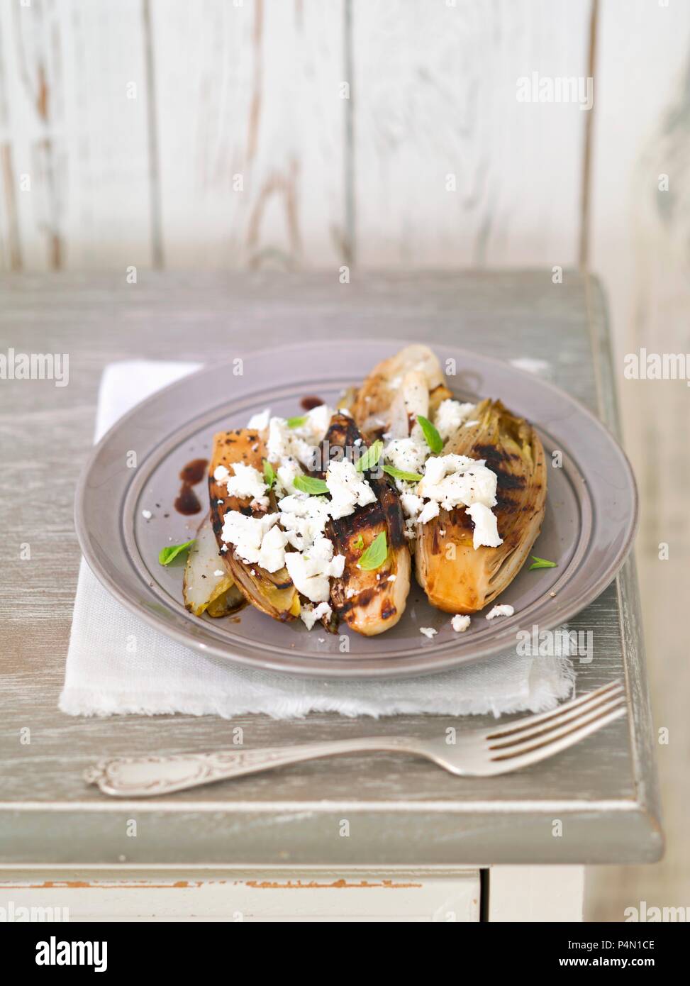Grilled chicory with feta cheese Stock Photo - Alamy