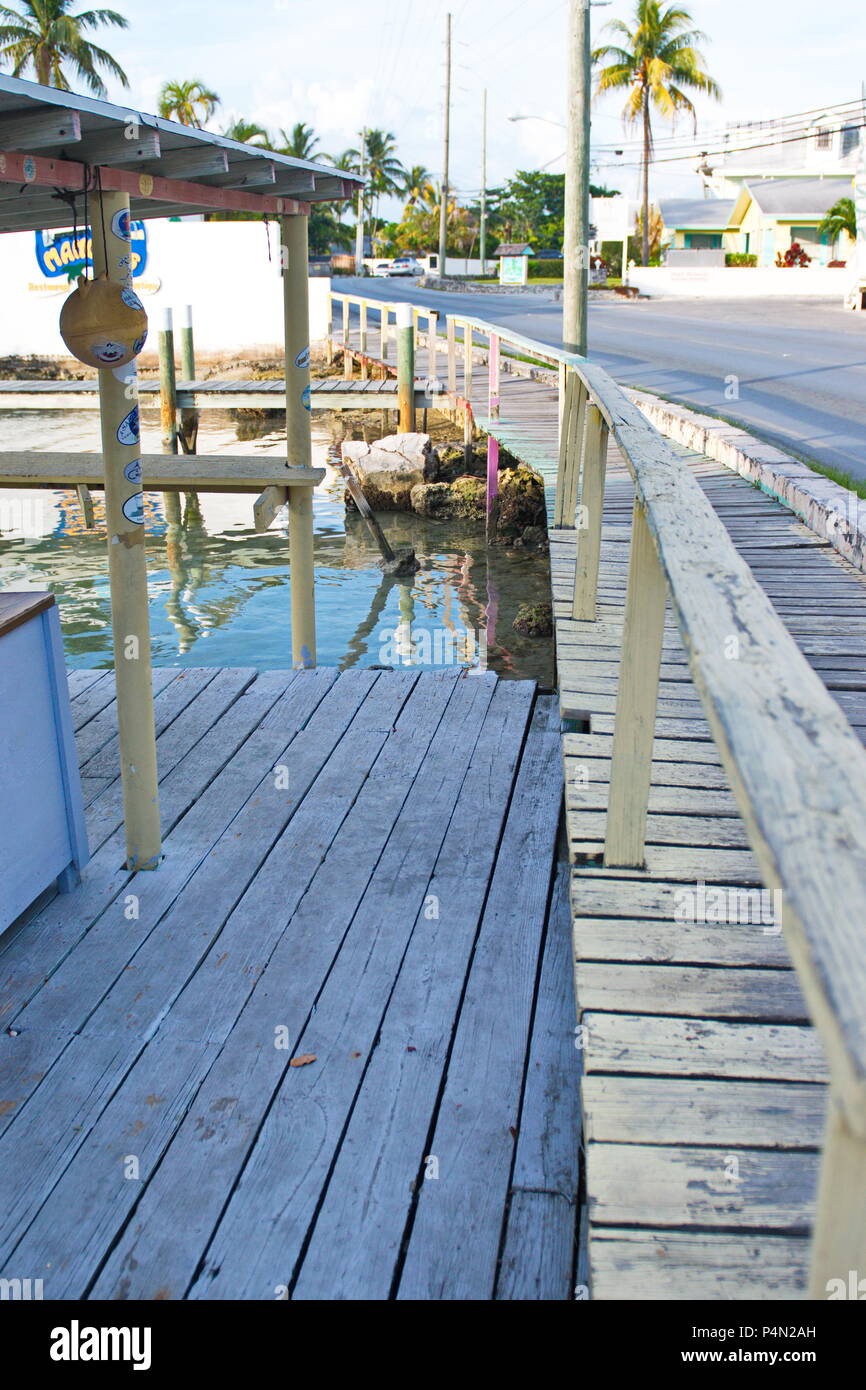 Old wooden walkway and dock along the coastline of Marsh Harbour ...