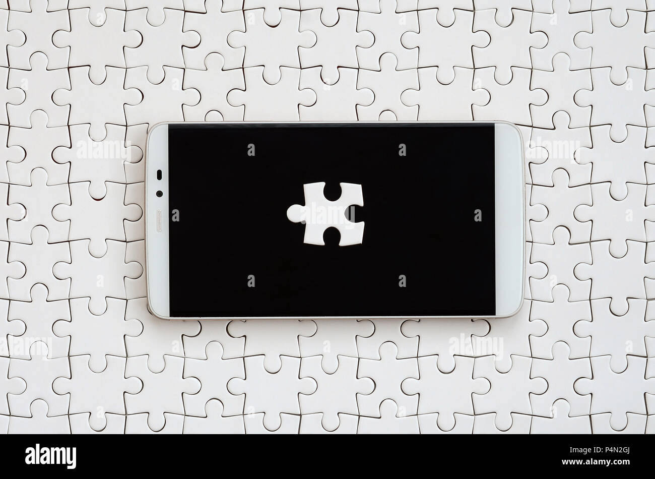 A modern big smartphone with several puzzle elements on the touch ...