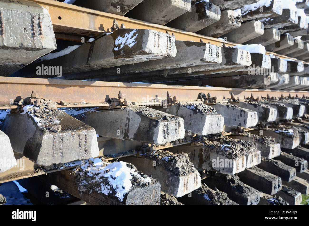 A lot of old rails and sleepers are stacked in a railway warehouse in ...