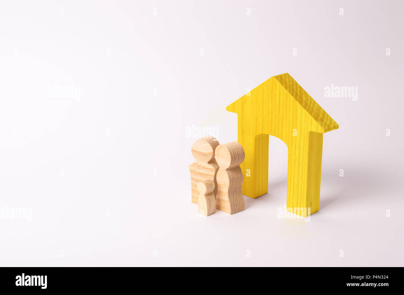 Figures of people stand near a wooden house on a white background. A ...