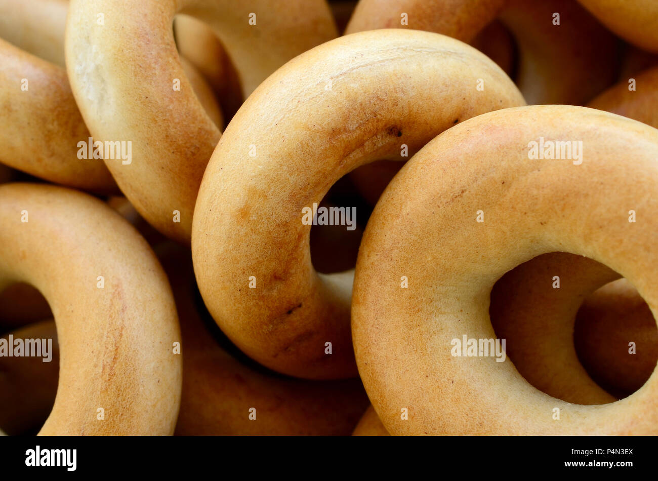 Close-up photo of fresh yellow bagels. A popular kind of flour products ...