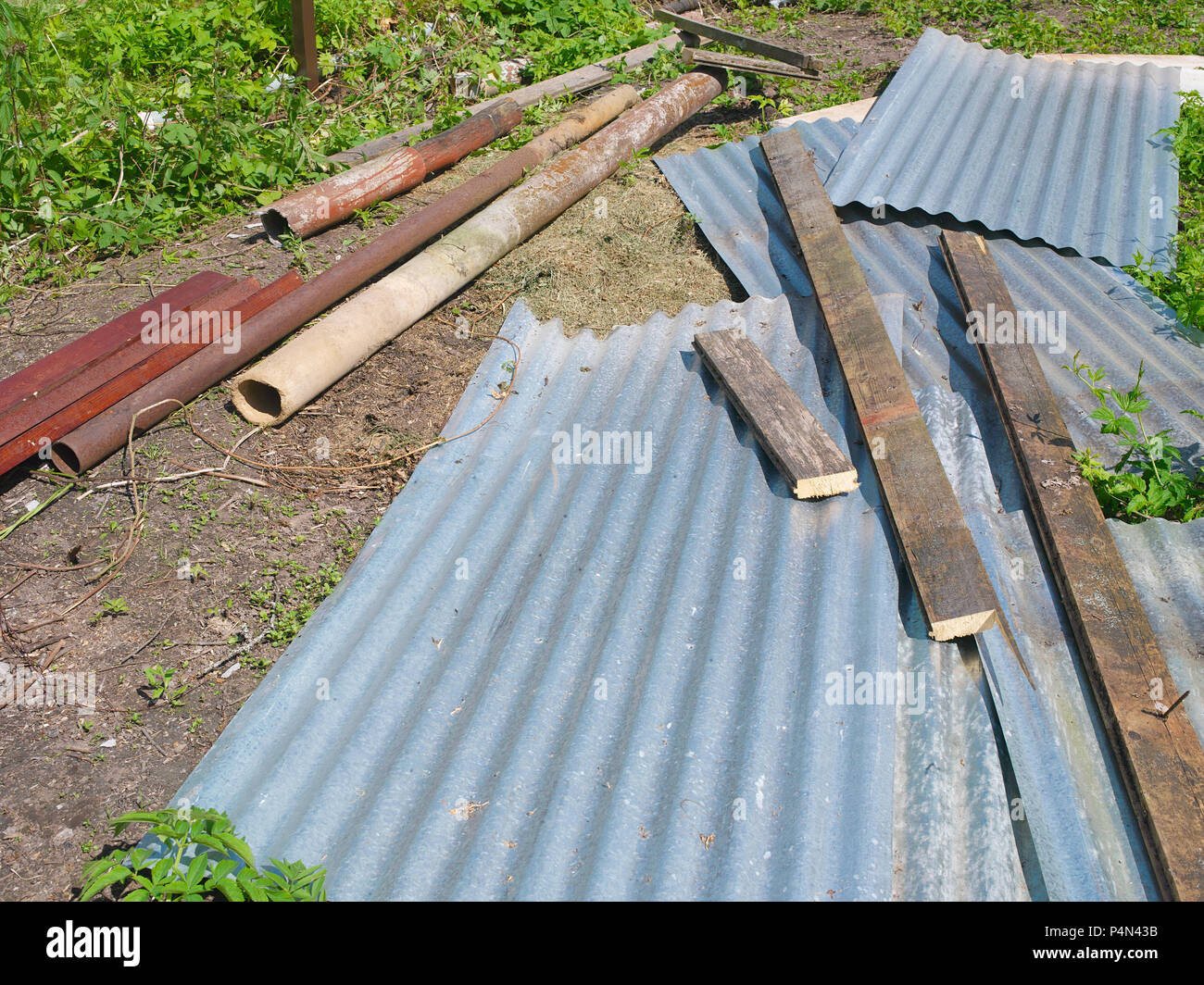 Various construction materials laid on the ground in mess Stock Photo ...
