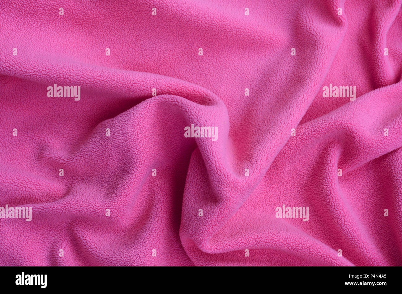 The blanket of furry pink fleece fabric. A background of light pink ...