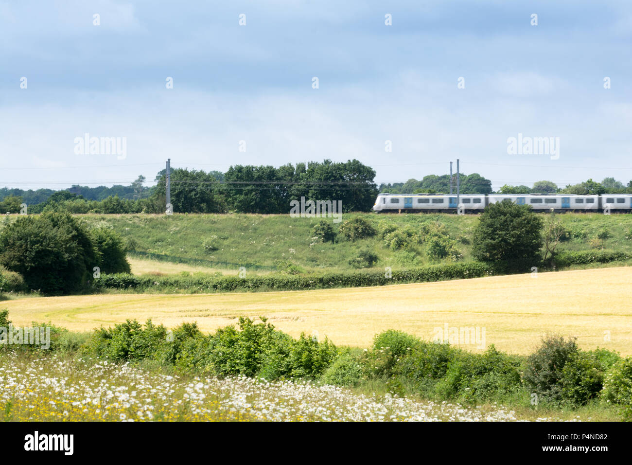 Train on the railway travelling through rural countryside Stock Photo ...