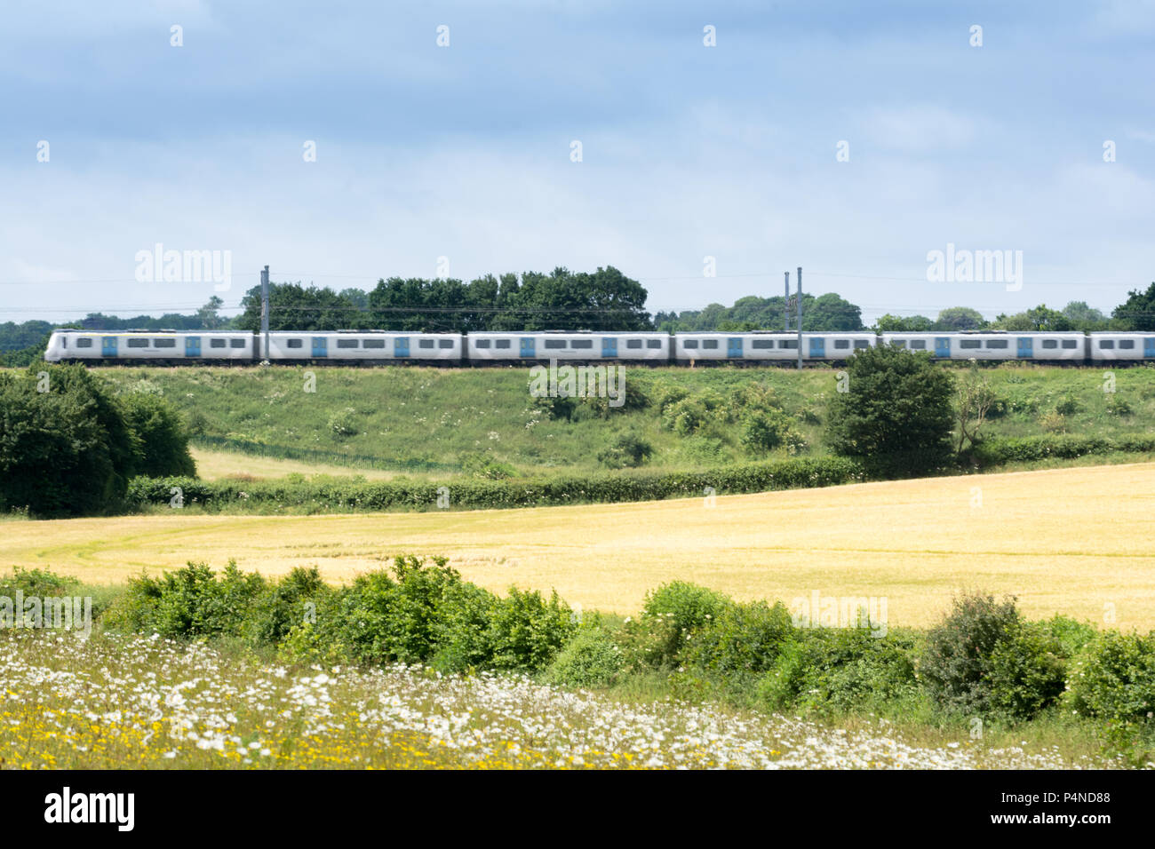 Train on the railway travelling through rural countryside Stock Photo ...