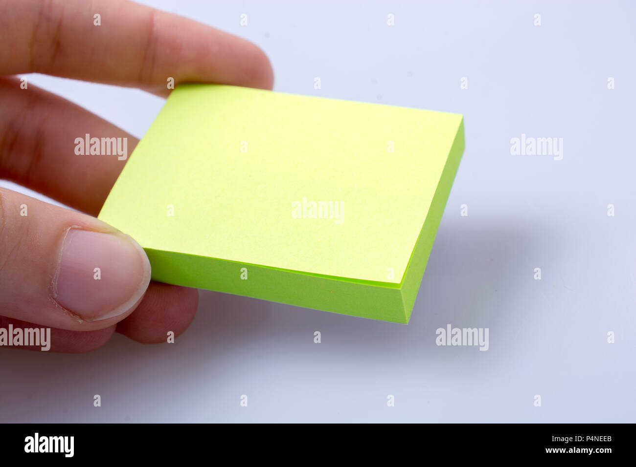 Post note office sticker for taking notes in hand Stock Photo - Alamy