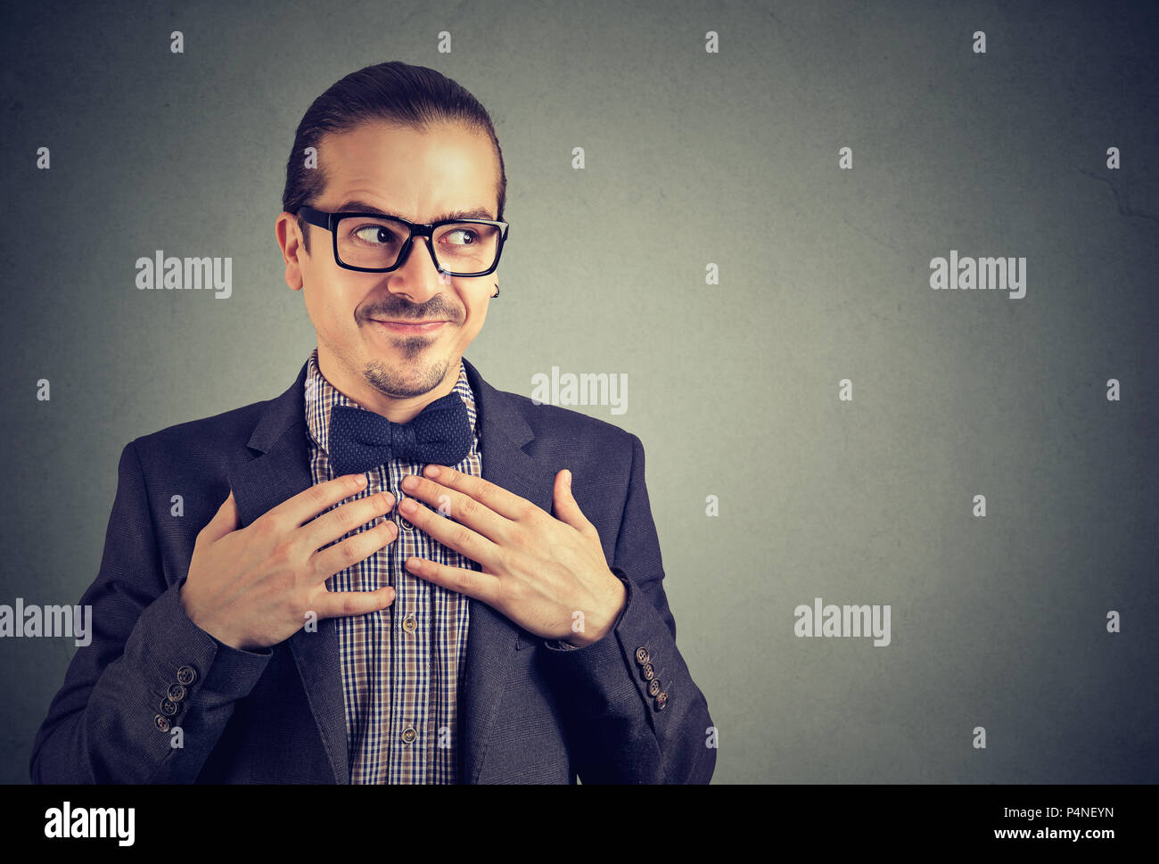 Young crazy man in glasses and suit looking nerdy away holding hands on ...