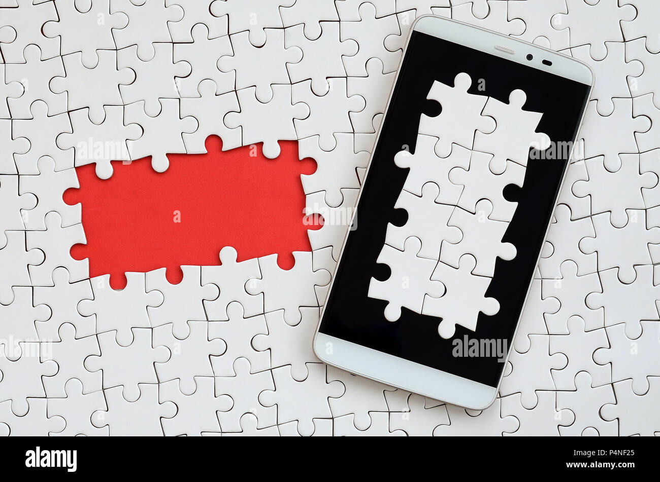 A modern big smartphone with several puzzle elements on the touch ...
