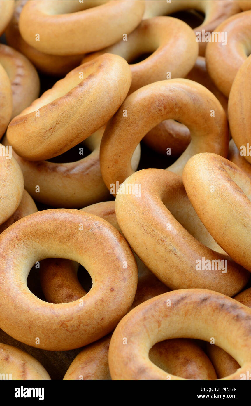 Close-up photo of fresh yellow bagels. A popular kind of flour products ...