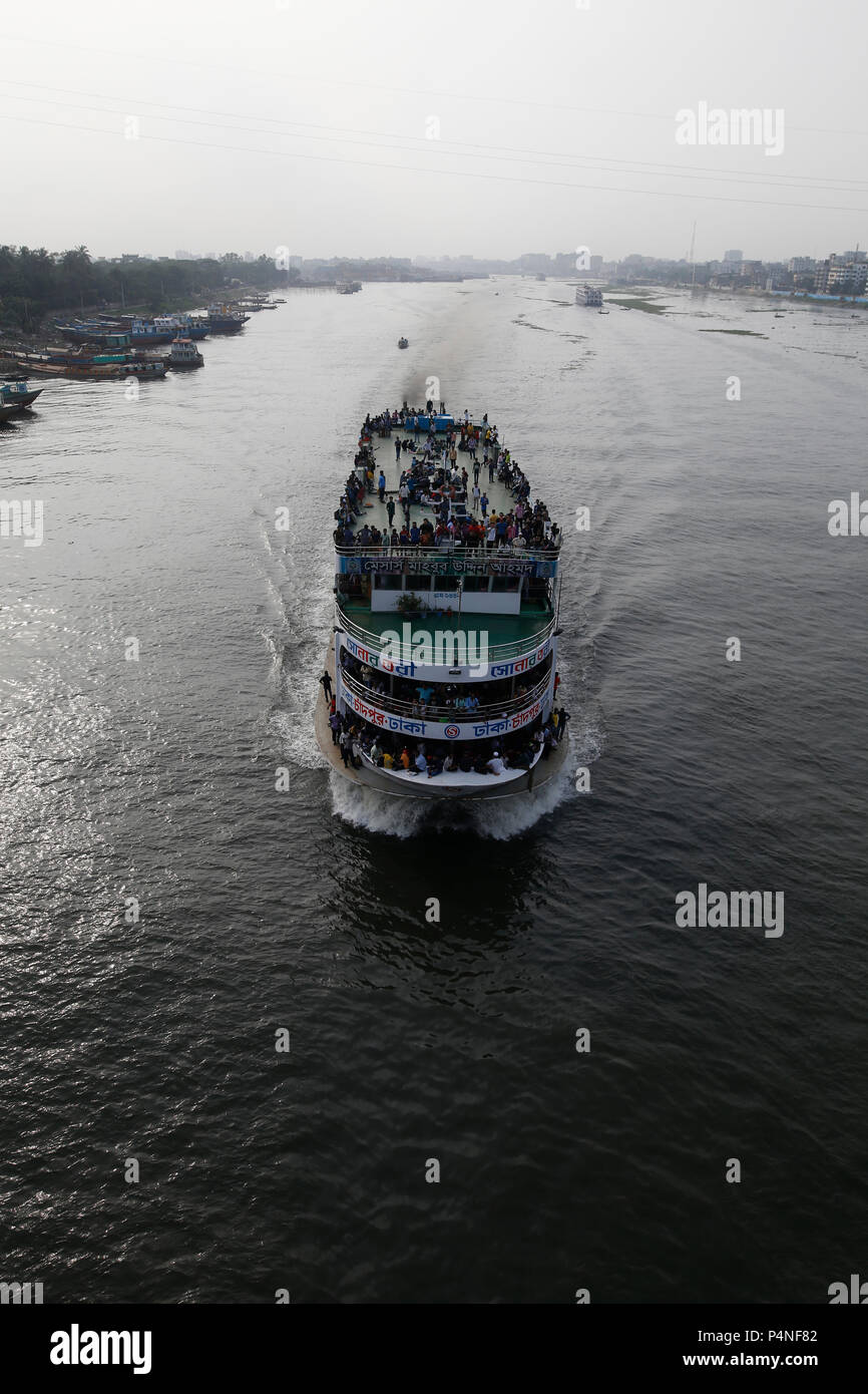 People travel on an overcrowded ferry along the Buriganga River in ...