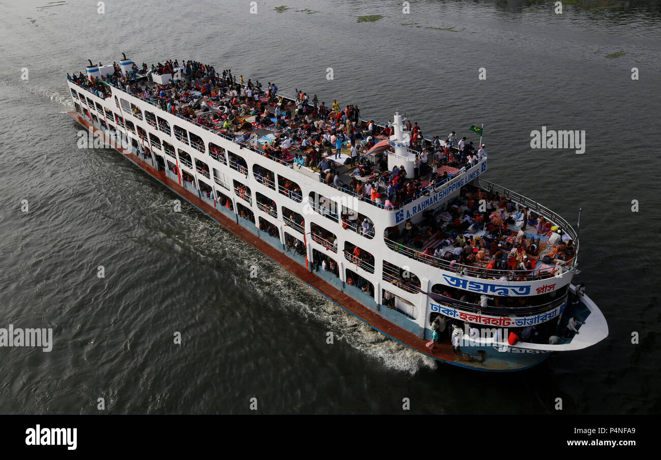 People travel on an overcrowded ferry along the Buriganga River in ...
