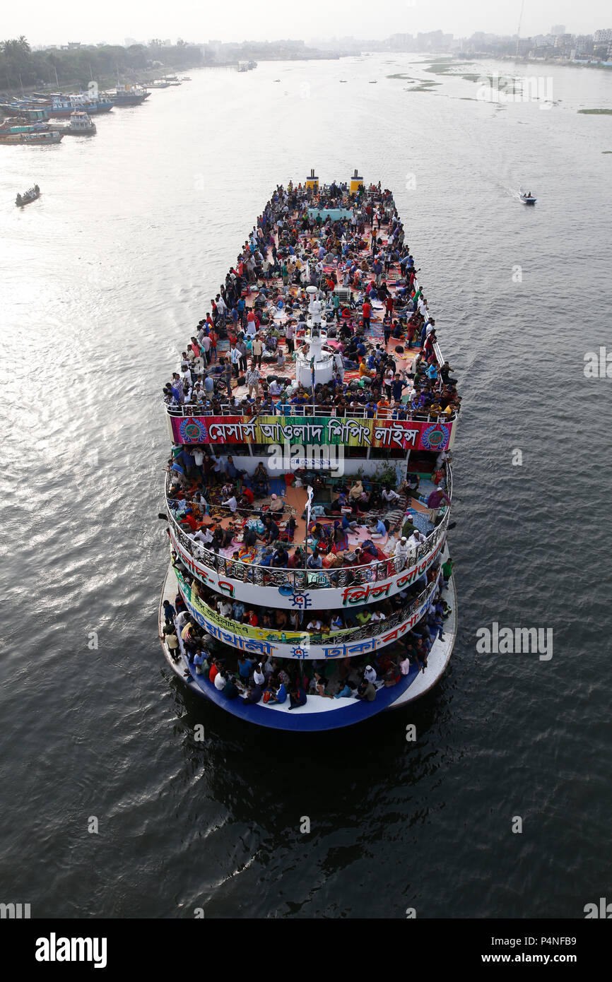 People travel on an overcrowded ferry along the Buriganga River in ...